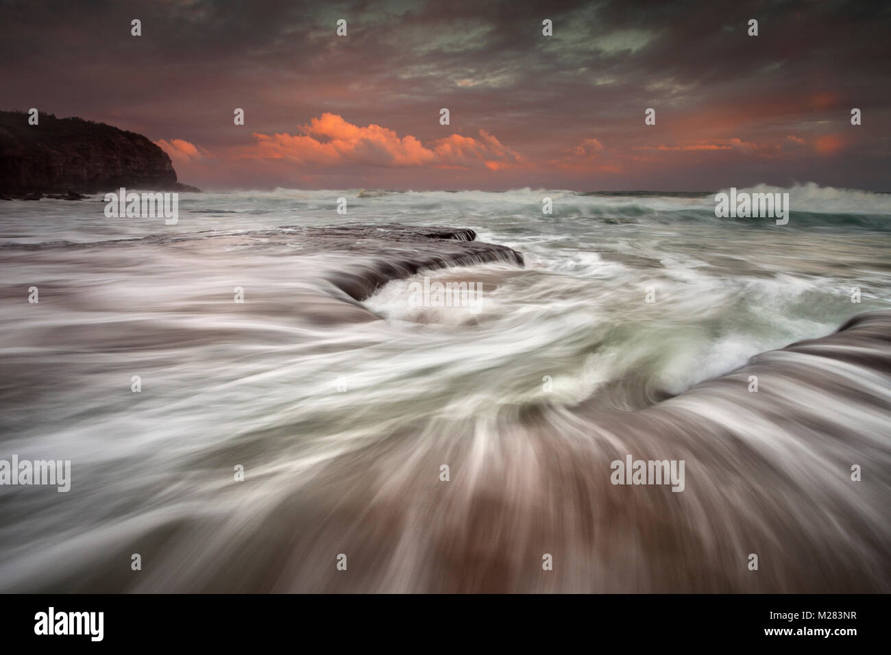 A long exposure creates interesting movement as the waves flow out to ...