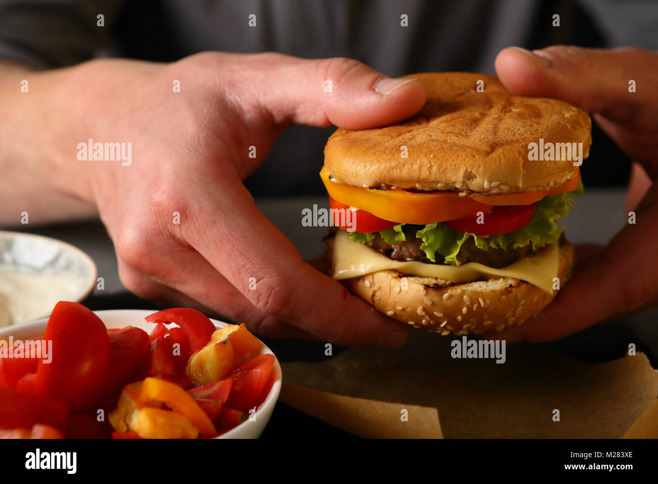 Burger and hands Stock Photo - Alamy