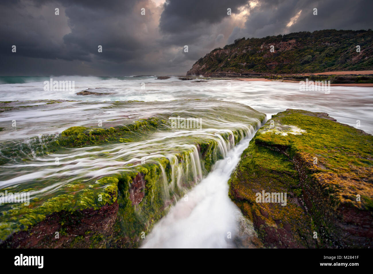 Water falls off the green mossy rocks of Turimetta, on Sydney's ...