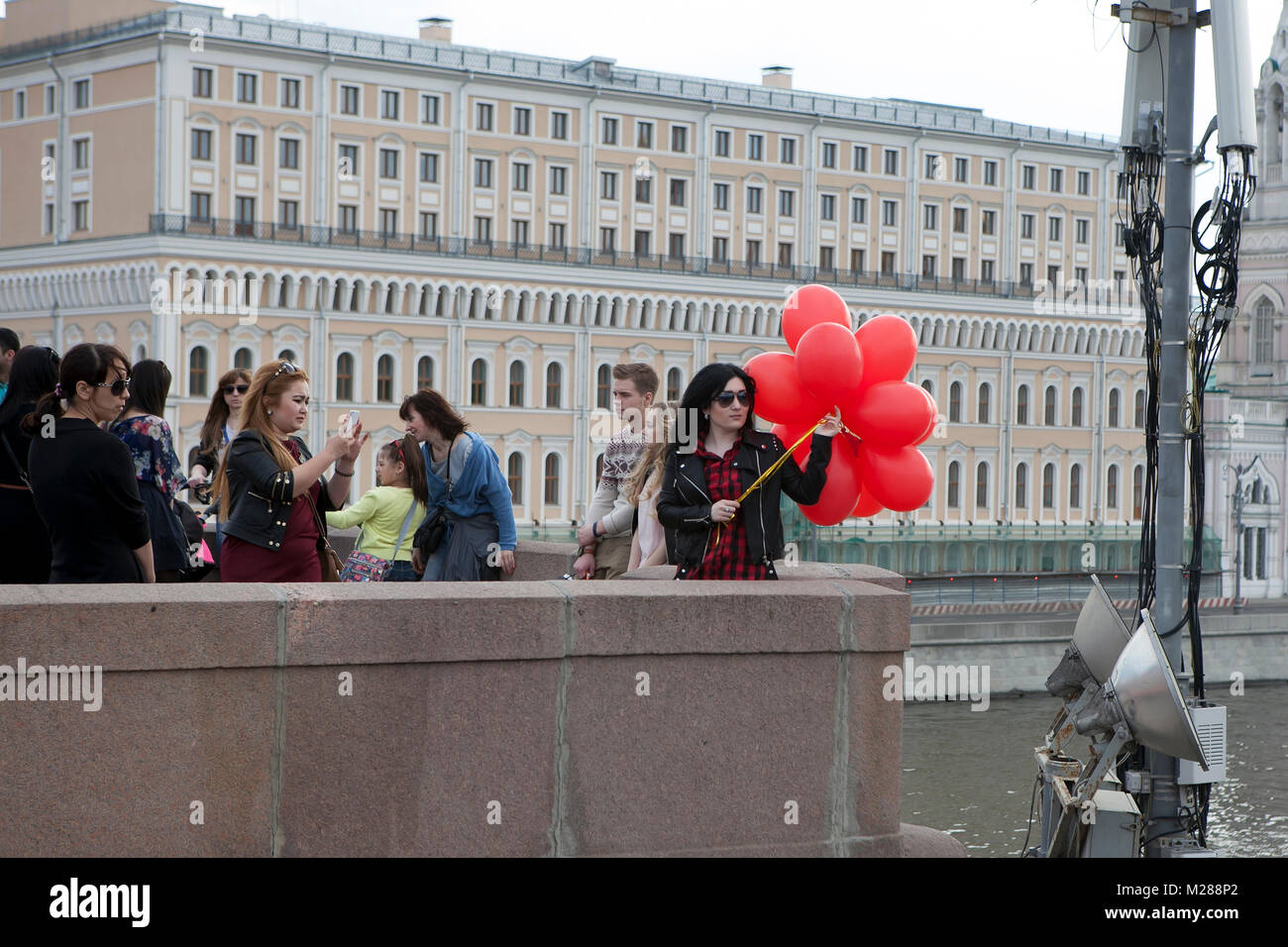 Moscow, Russia - 21 June 2017 A girl with red balloons posing on a ...