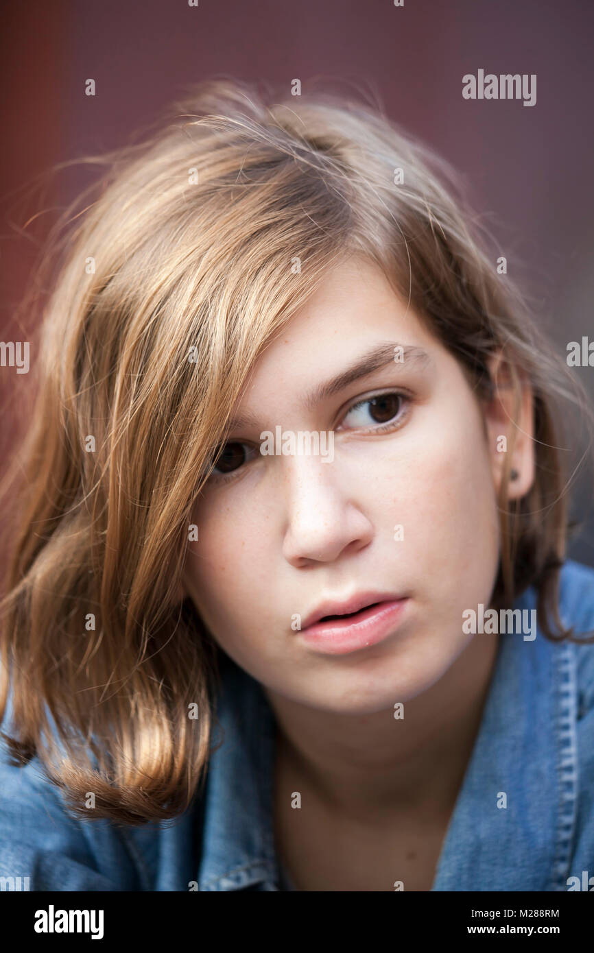 Portrait of a pensive young girl with a hairstyle Stock Photo - Alamy