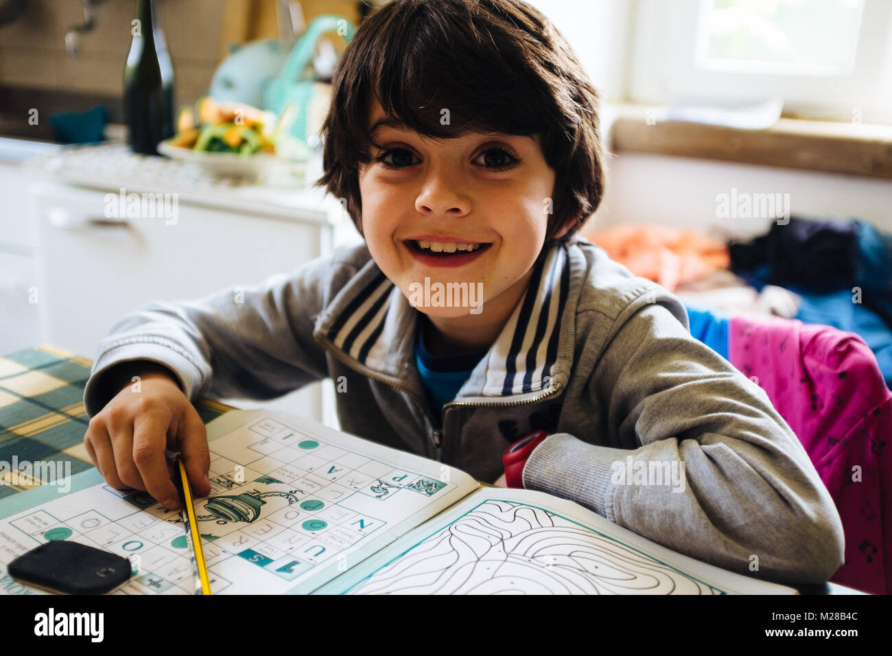 Child carries homework at the table of kitchen Stock Photo - Alamy
