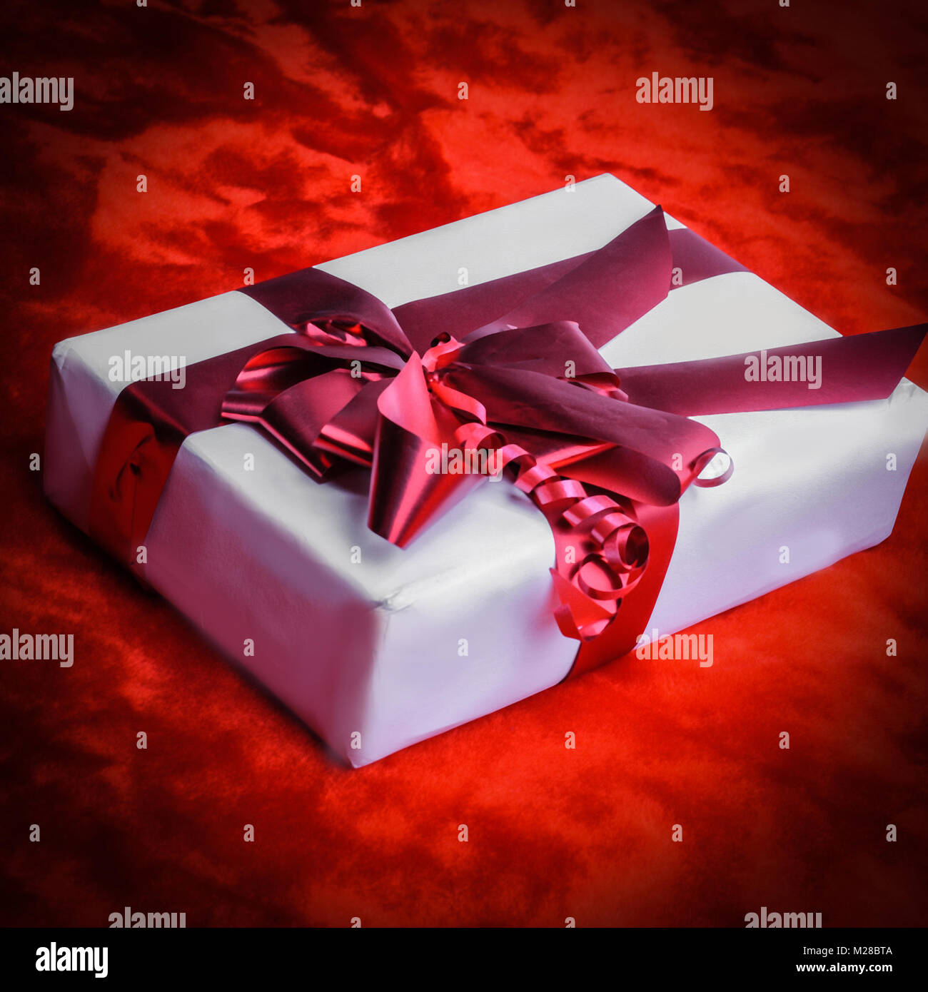 closeup.boxes with gifts with ribbon .isolated on red Stock Photo - Alamy