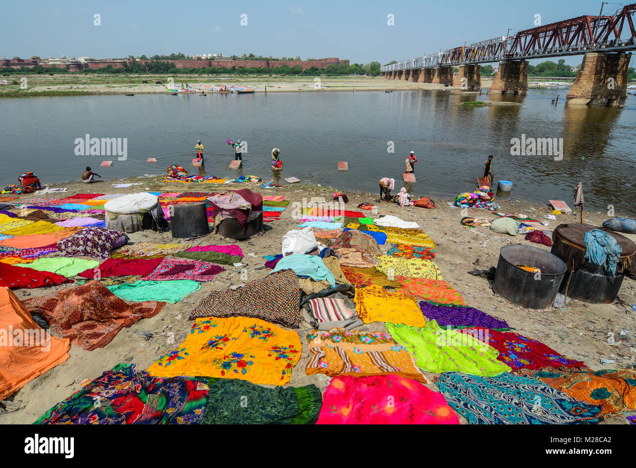Agra, India - Jul 13, 2015. People dye traditional clothes on Yamuna ...