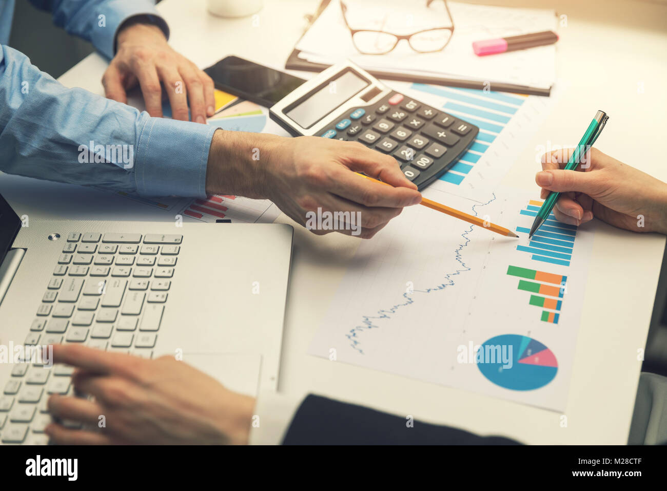 office teamwork - business people discussing graph and chart reports ...