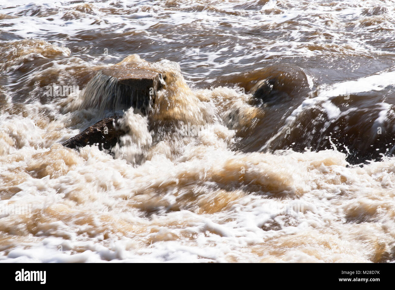 water in fast flowing river flowing over rocks in rapids at cobblers ...