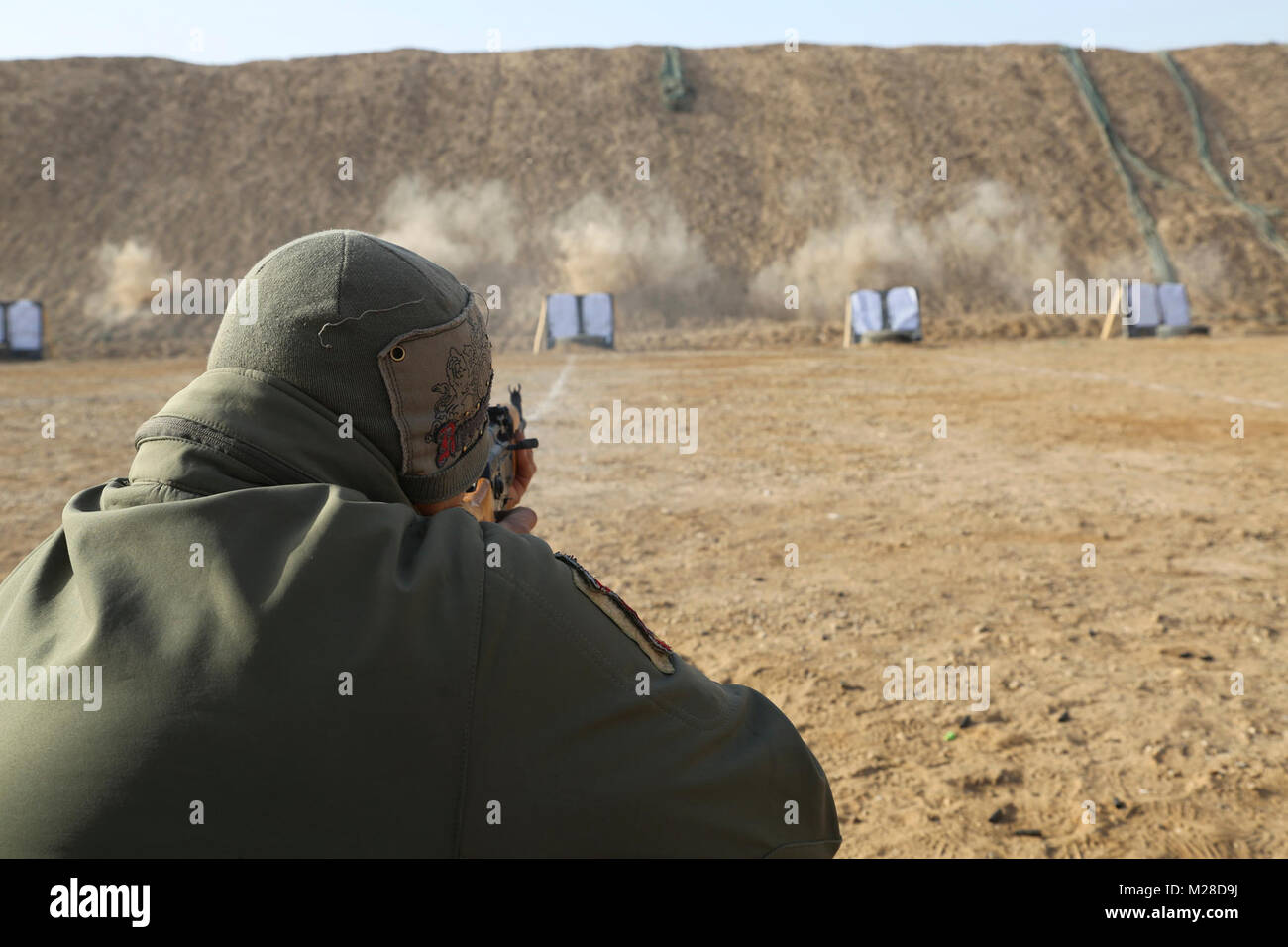 An Iraqi soldier fires his AK47 rifle from the standing position during ...