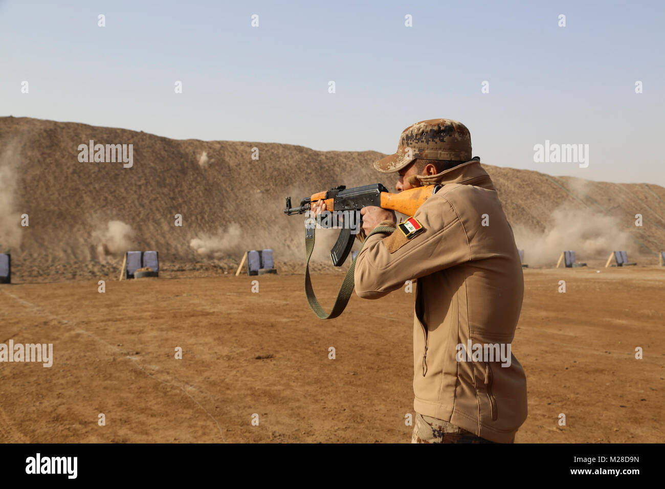 An Iraqi soldier takes the proper stance as he fires his AK47 rifle ...