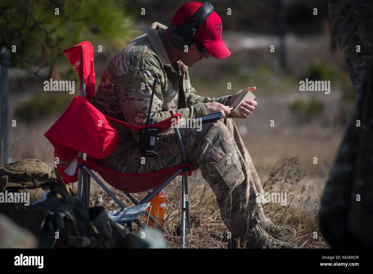 A Combat Arms Training and Maintenance (CATM) instructor carves a piece ...