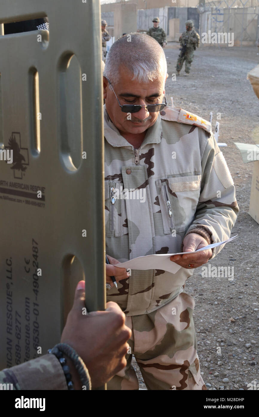 An Iraqi army officer looks at paperwork for spineboards to be received ...