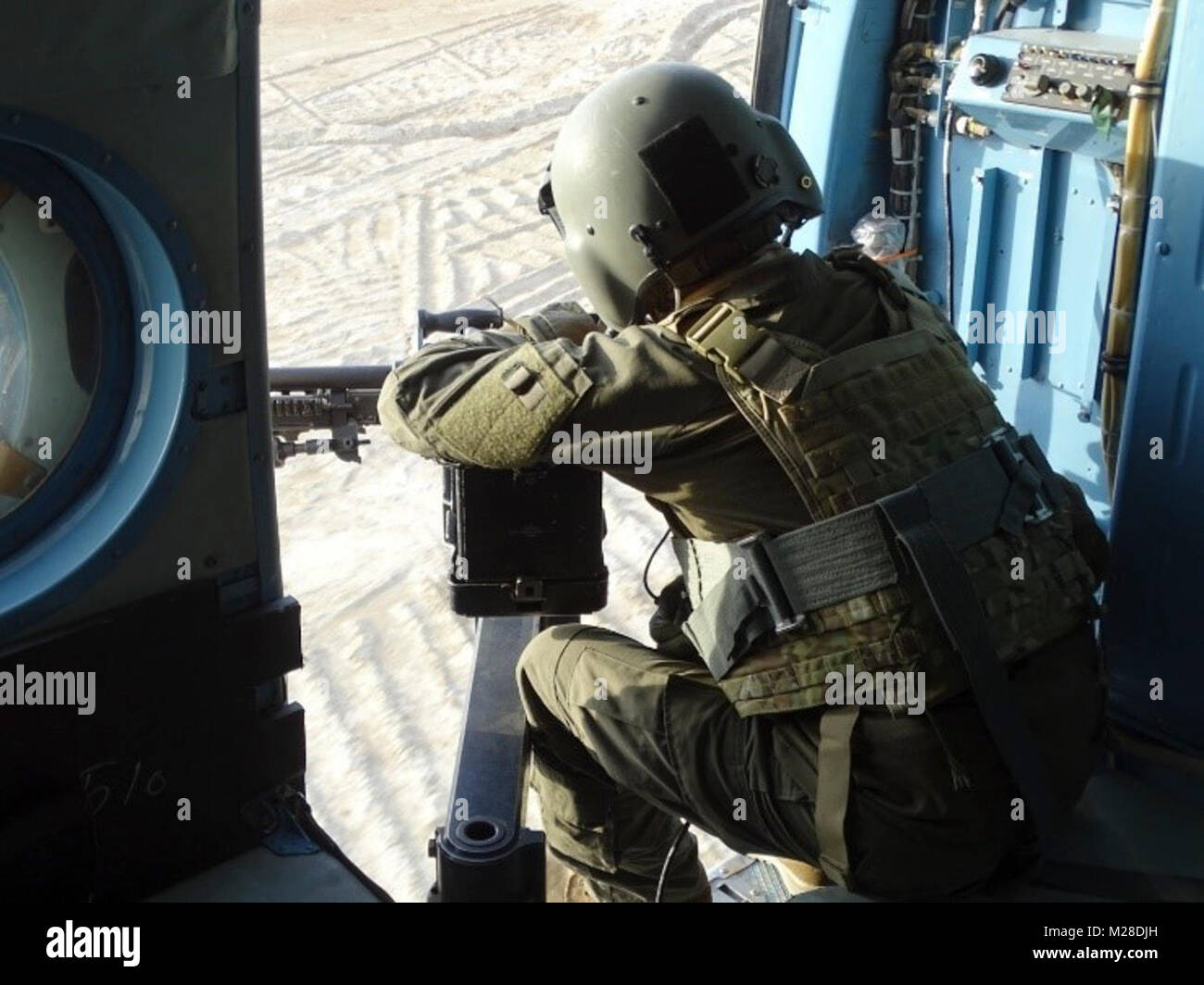 An Afghan 777 Special Mission Wing Mi-17 crew chief controls his M240B ...