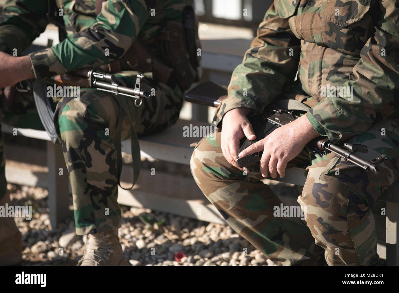 Security force members listen to instructions while learning basic ...