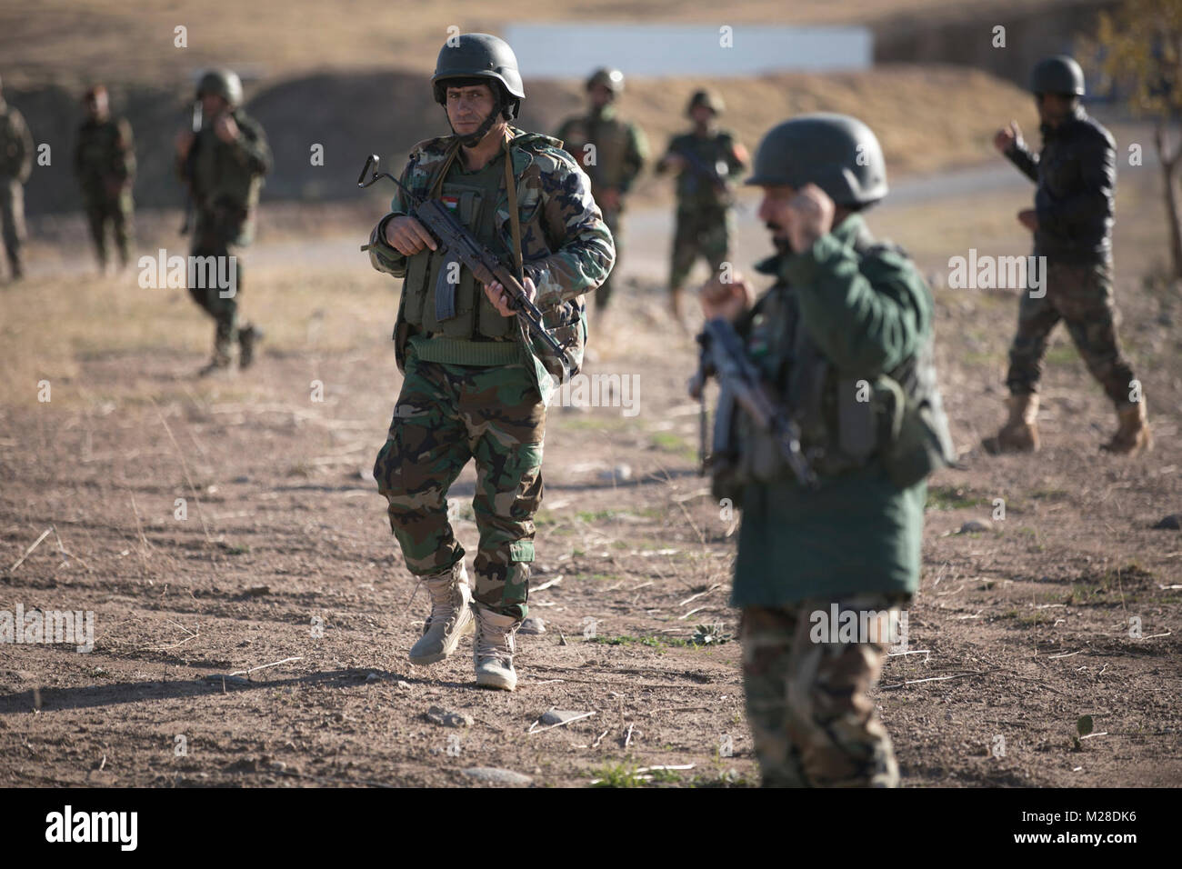 Security force members follow the hand signals of the squad leader ...