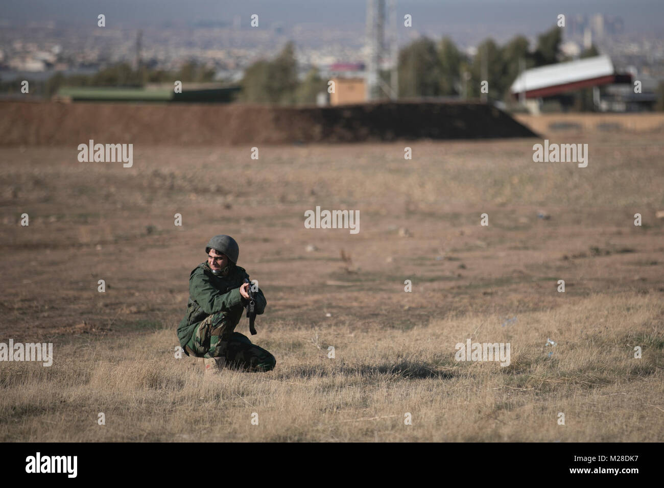 A security force member watches for hand signals from the squad leader ...
