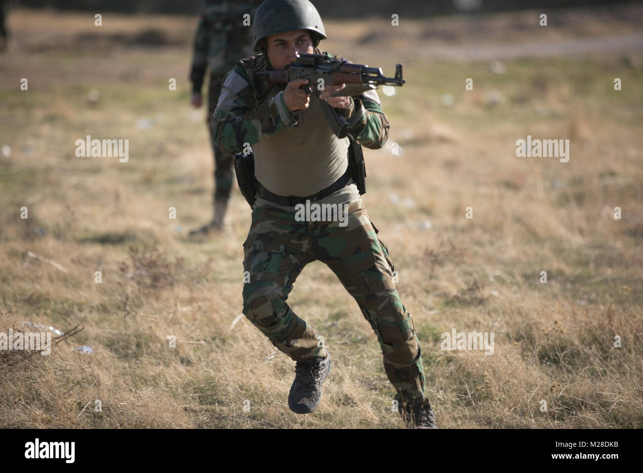 A security force member moves forwards during drills while learning ...