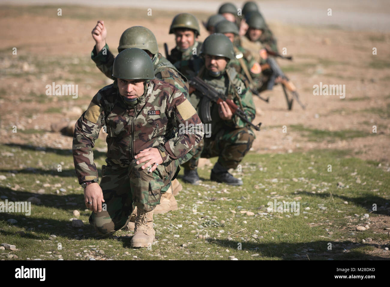 Security force members follow the hand signals of the squad leader ...