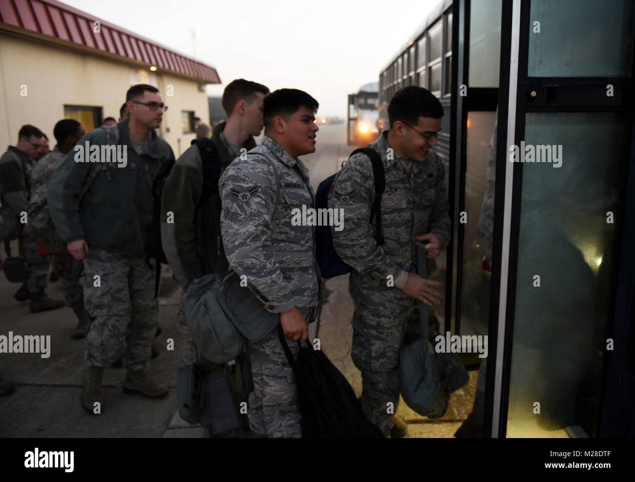 Members of the 60th Maintenance Squadron file onto a bus to take them ...