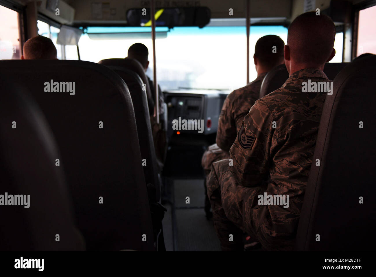 Airmen with the 60th Maintenance Group ride on a bus to take them out ...