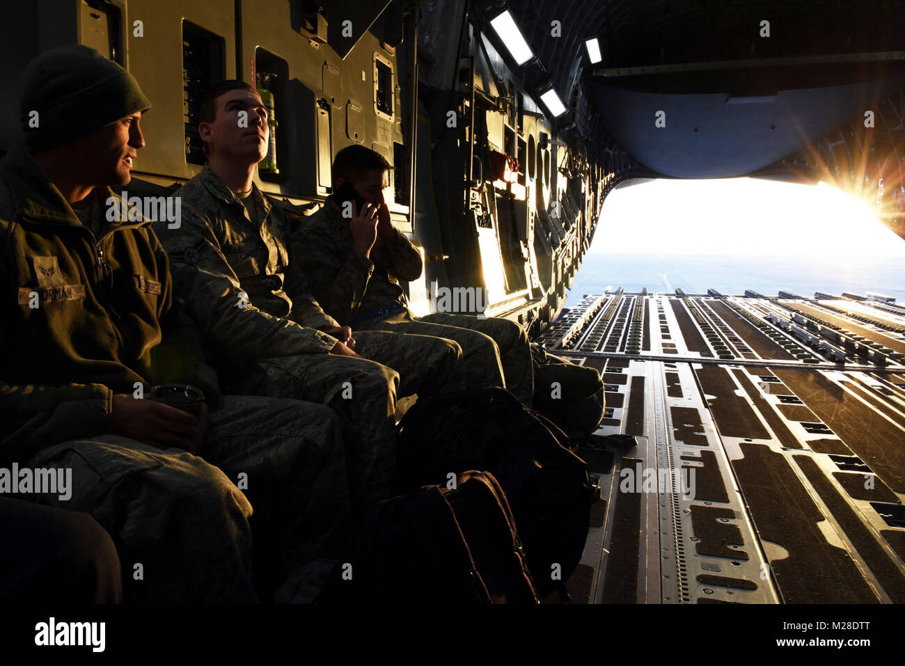 Airmen with the 60th Maintenance Group sit on a C-17 Globemaster III ...