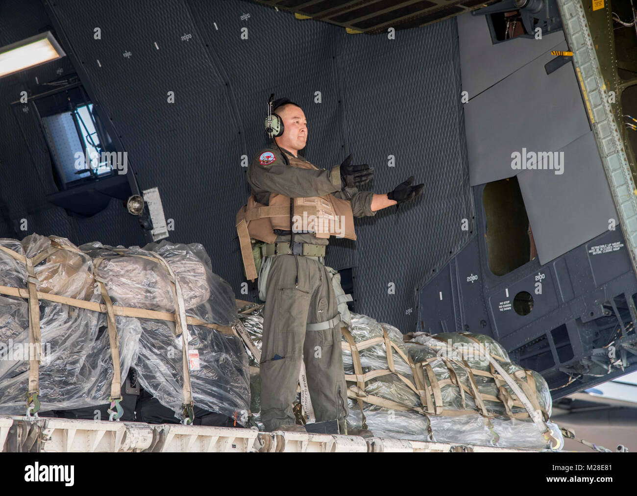 Senior Airman Justin Han, 22nd Airlift Squadron loadmaster, marshals a ...