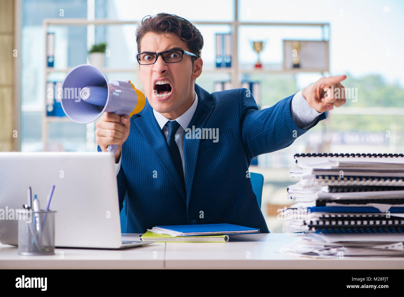 Angry aggressive businessman with bullhorn loudspeaker in office Stock ...