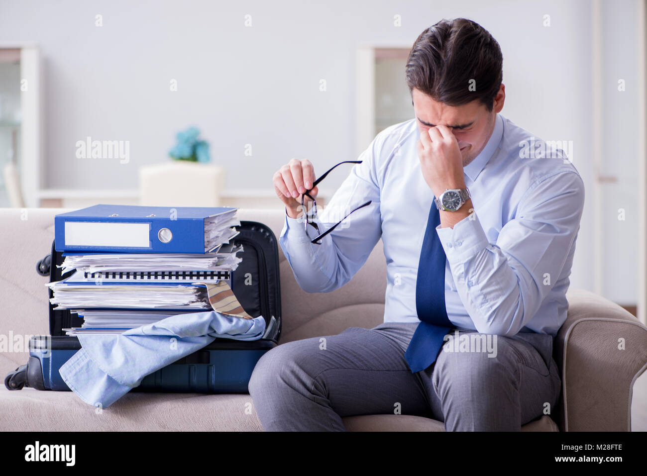 Businessman preparing packing for business trip Stock Photo - Alamy