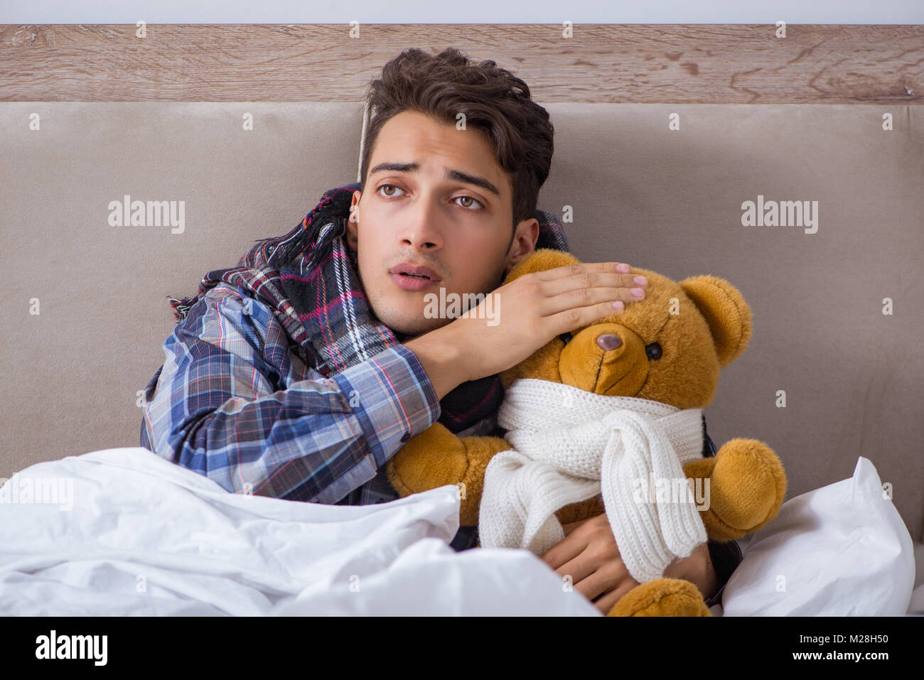 Sick man suffering from flu in the bed Stock Photo - Alamy
