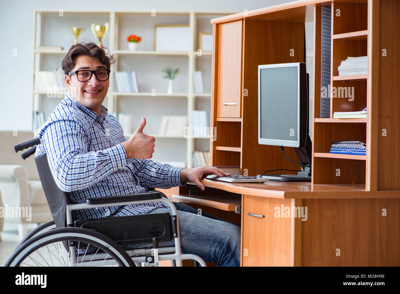 Disabled student studying at home on wheelchair Stock Photo - Alamy