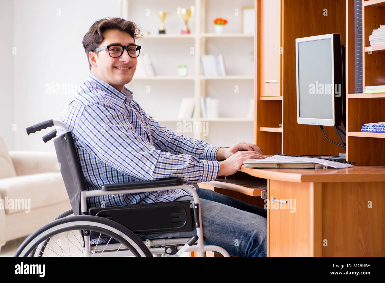 Disabled student studying at home on wheelchair Stock Photo - Alamy