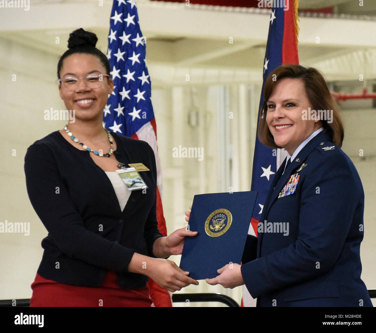 Ms. Leah Jones presents an award to Col. Allison Miller on behalf of U ...