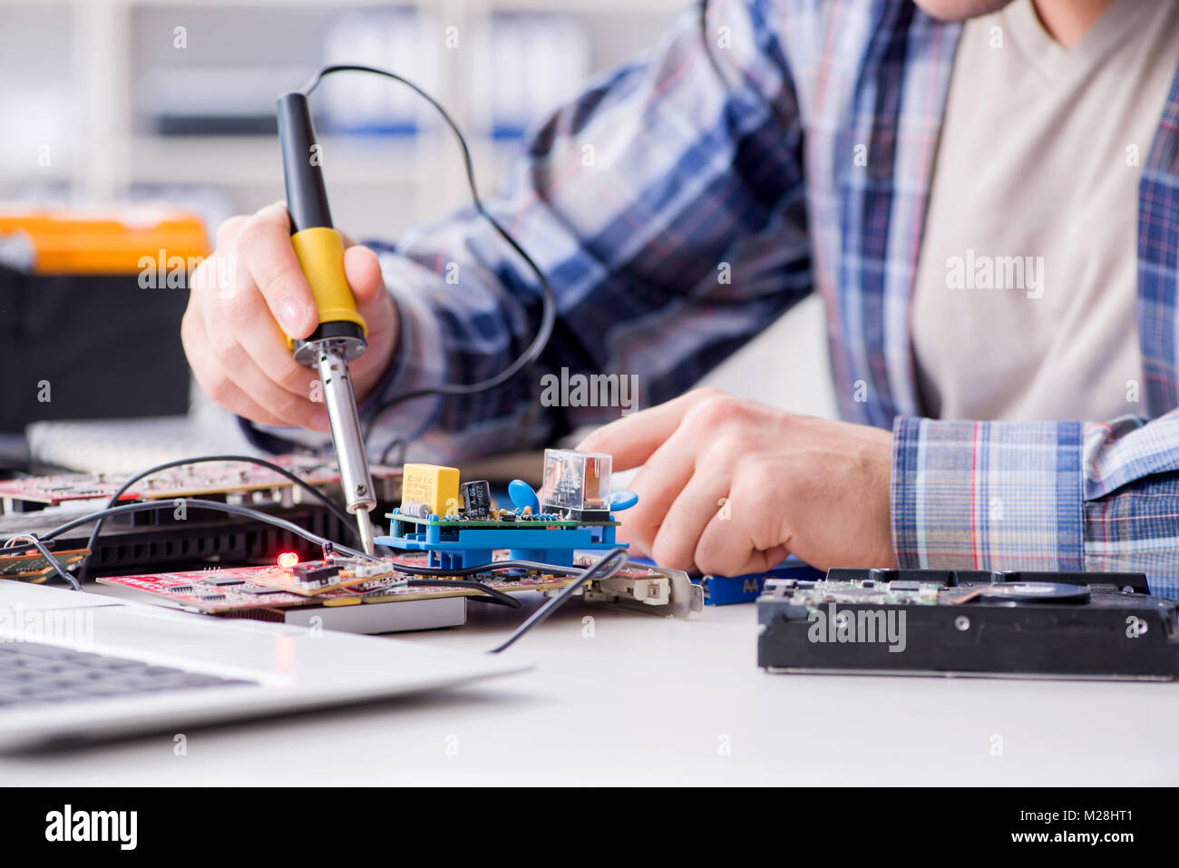 Professional repairman repairing computer in workshop Stock Photo - Alamy