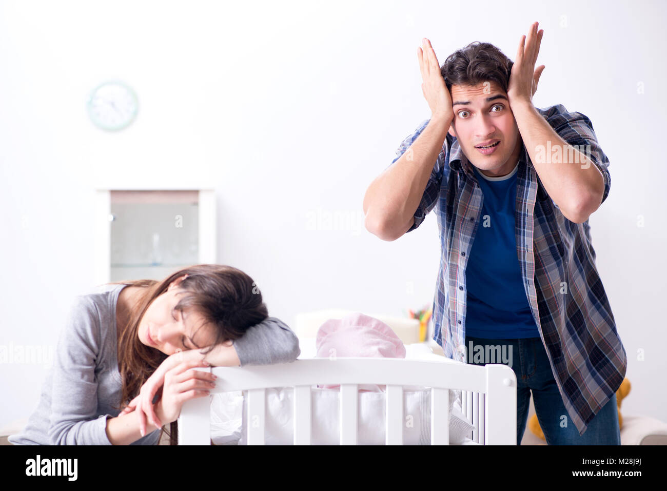 Young dad cannot stand baby crying Stock Photo - Alamy