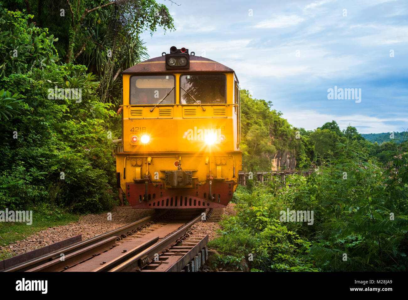 Old railroad tracks on bridge beside cliff rock Stock Photo - Alamy