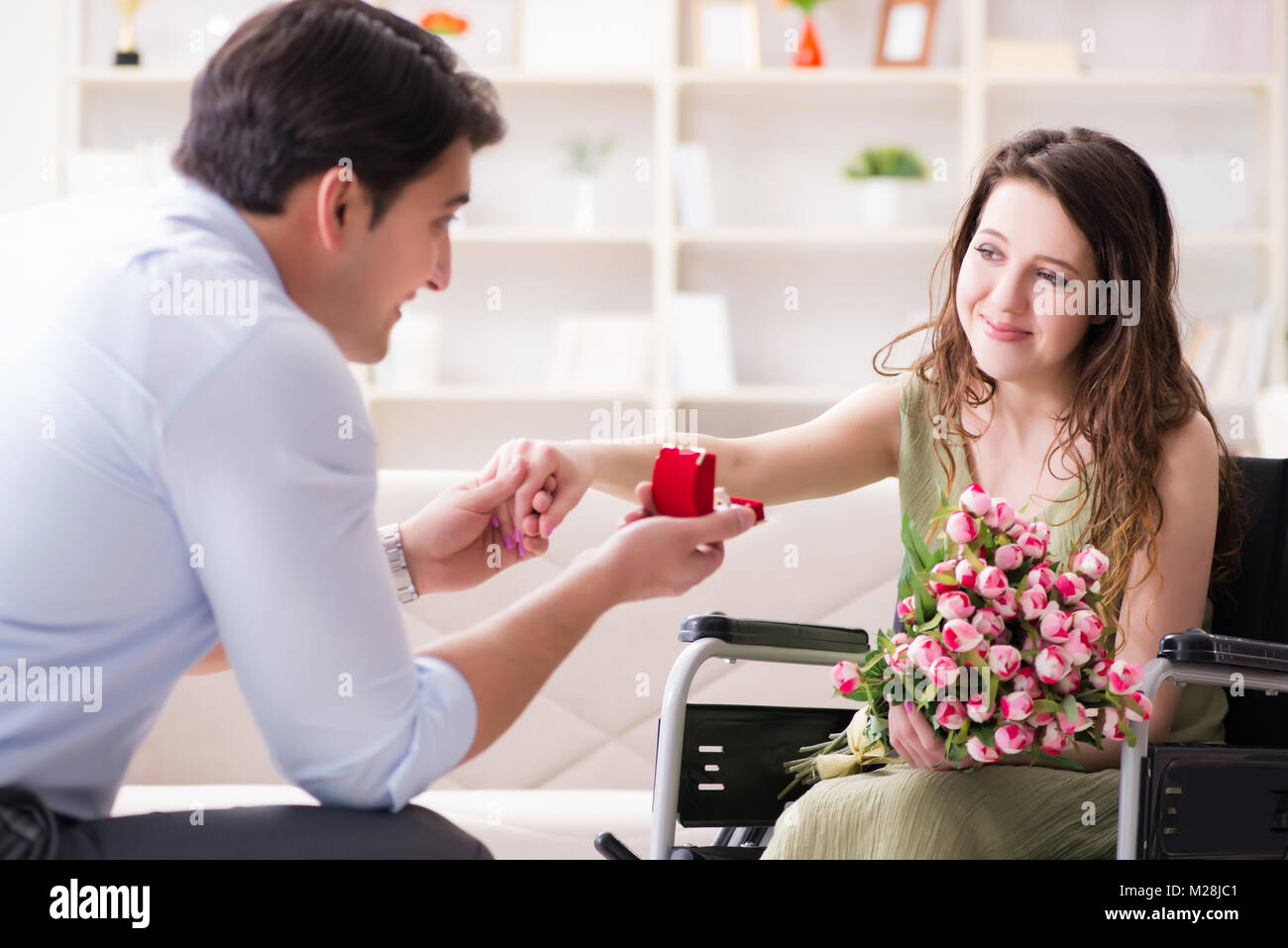 Man making marriage proposal to disabled woman on wheelchair Stock ...