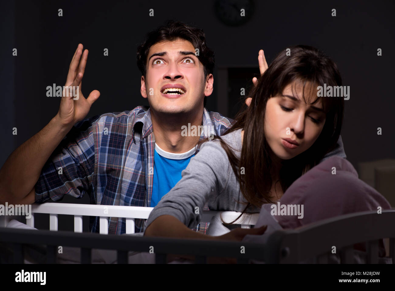 Young parents sleepless with newborn baby at night Stock Photo - Alamy