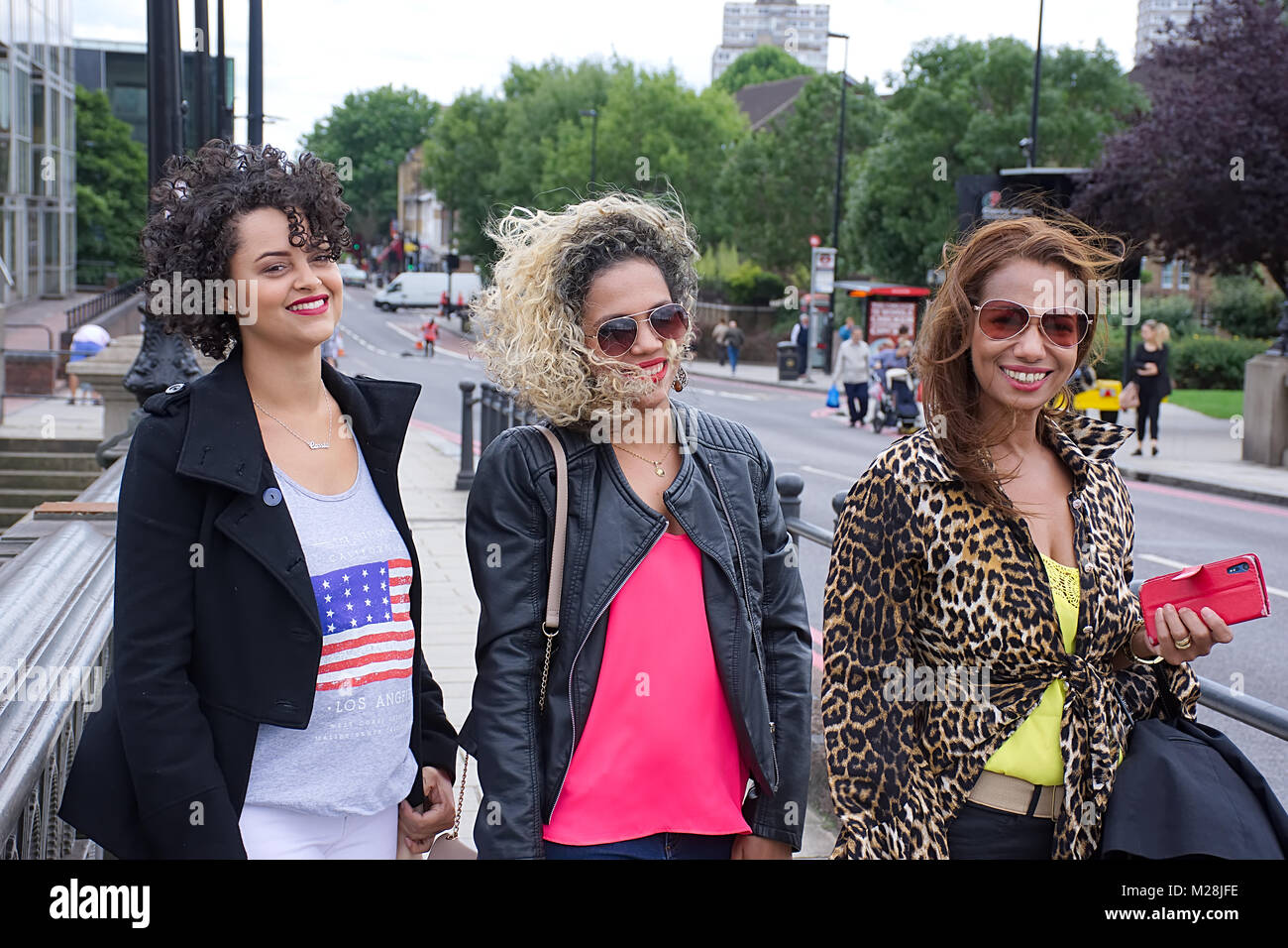 Three middle aged woman posing for picture on Battersea Bridge in ...