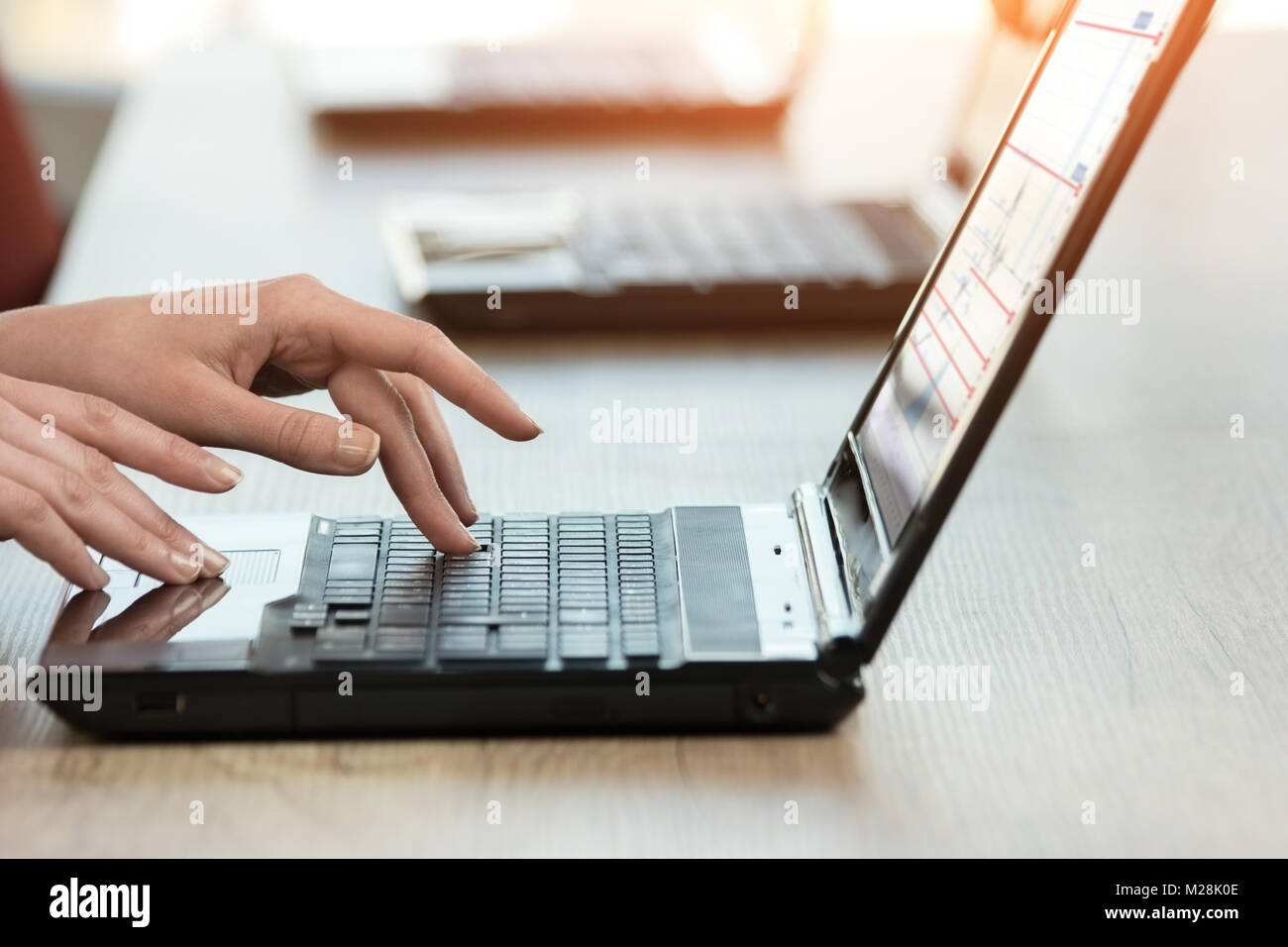 Pressing button on laptop computer. Side view female hands typing on ...
