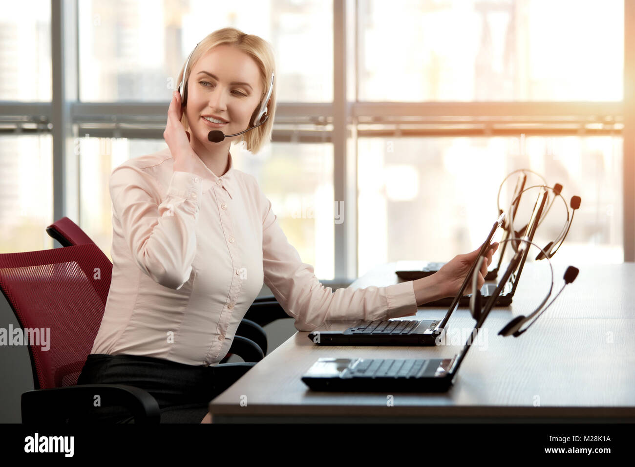 Sitting female call center operator looking back. Gaze of adorable ...