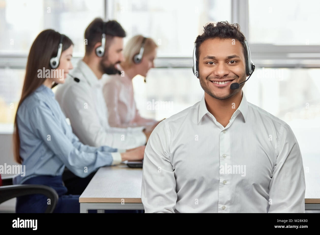 Young friendly male customer service operator. Portrait of a smiling ...