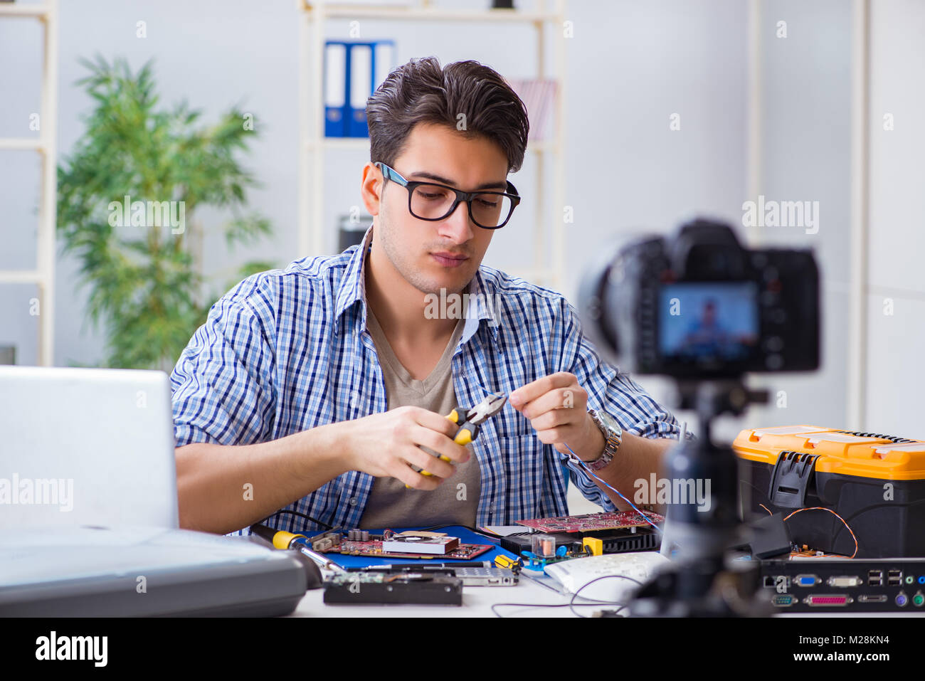 Vlogger recording computer repair on camera for vlog blog Stock Photo ...