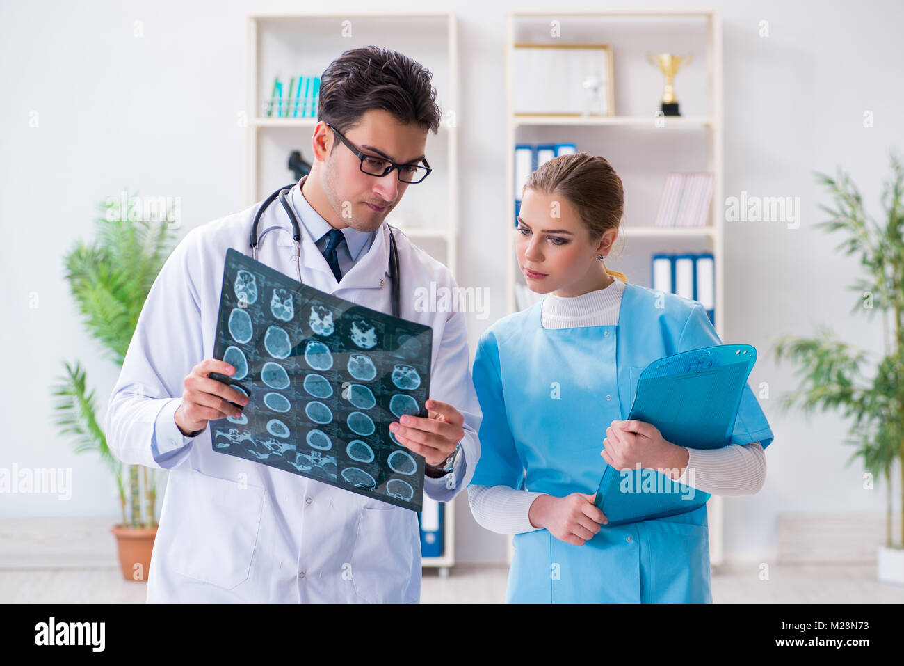Two doctors examining x-ray images of patient for diagnosis Stock Photo ...