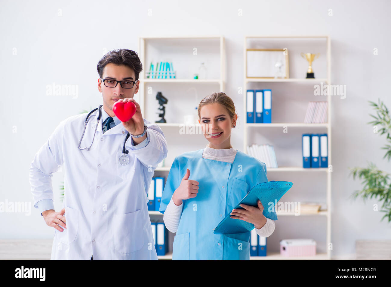 Cardiologist with his nurse assistant posing in hospital Stock Photo ...