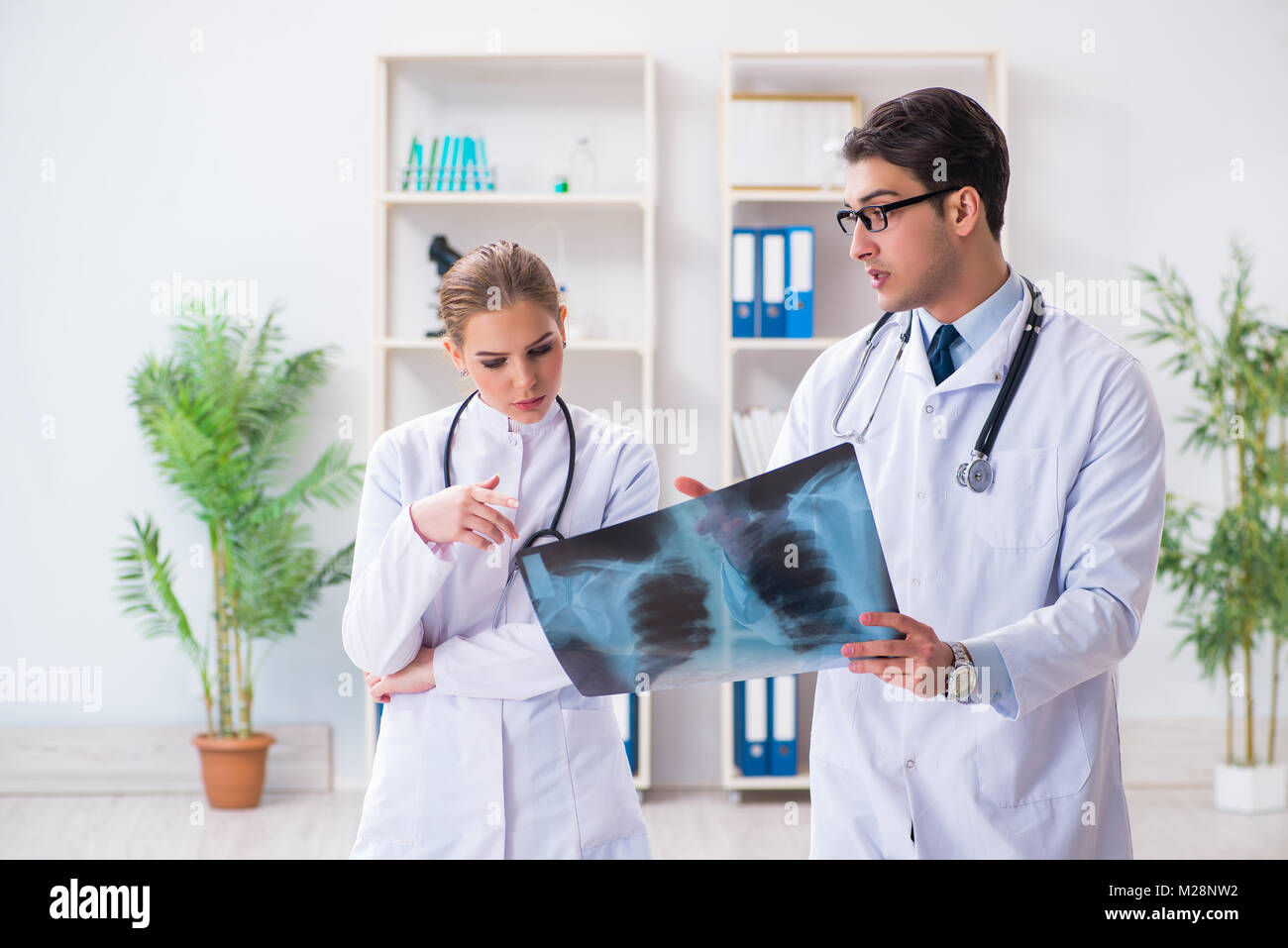 Two doctors examining x-ray images of patient for diagnosis Stock Photo ...
