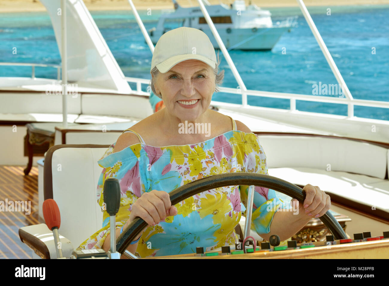 Amusing elderly woman have a ride in a boat on sea Stock Photo - Alamy