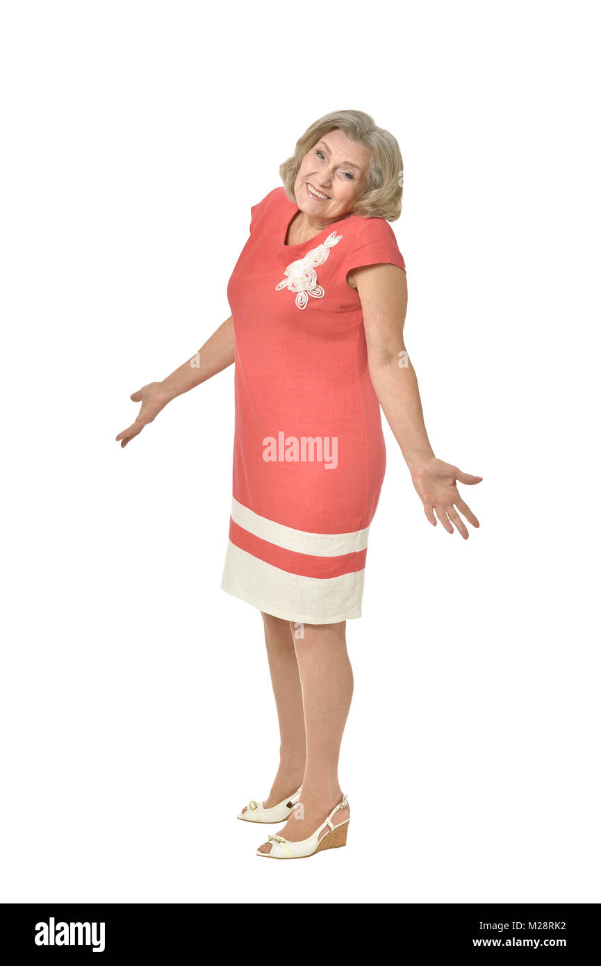 Portrait of senior woman in pink dress isolated on white background ...