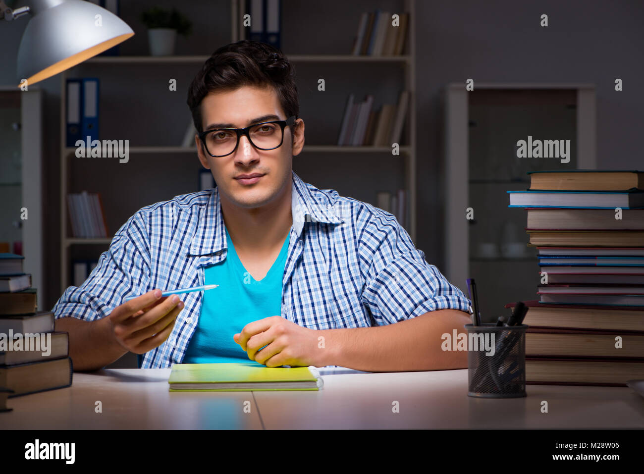 Student preparing for exams late night at home Stock Photo - Alamy