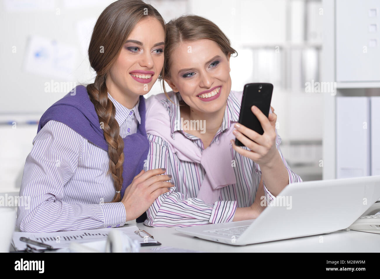 Young women with laptop working at modern office Stock Photo - Alamy
