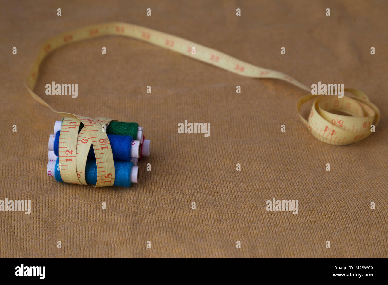 Sewing thread and Measuring Tape Stock Photo - Alamy