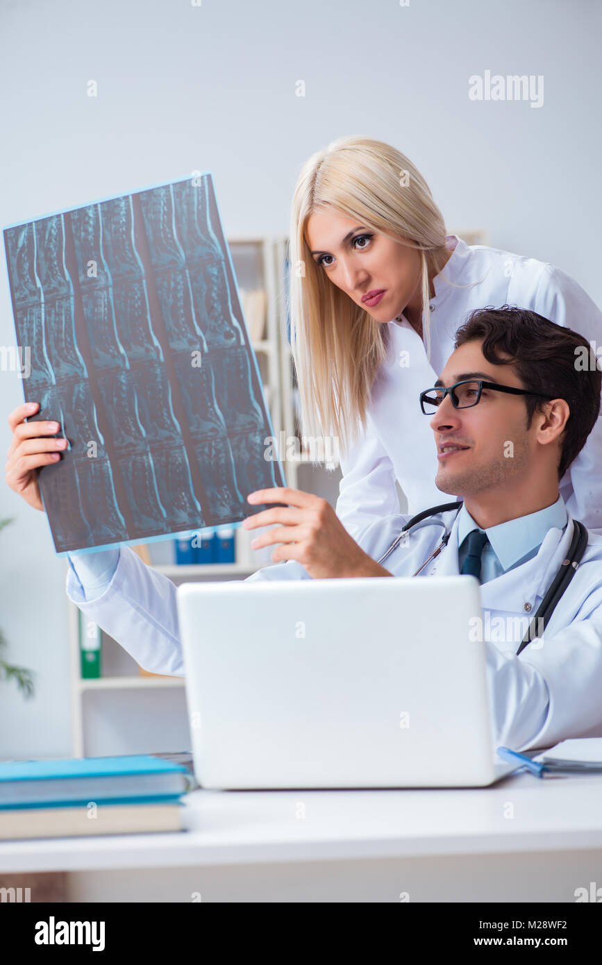 Two doctors examining x-ray images of patient for diagnosis Stock Photo ...