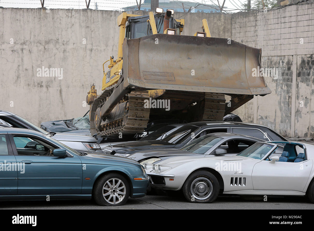 Manila, Philippines. 6th Feb, 2018. A bulldozer rolls over smuggled ...
